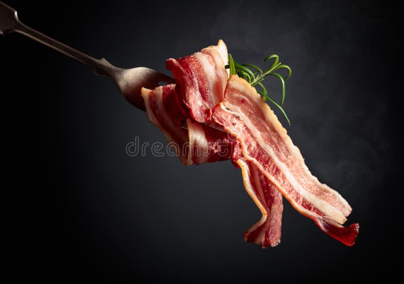Fried bacon on a fork stock image. Image of herb, bacon - 233619869