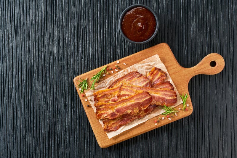 Fried Bacon Rashers and Bbq Sauce on a Black Table, Top View Stock ...