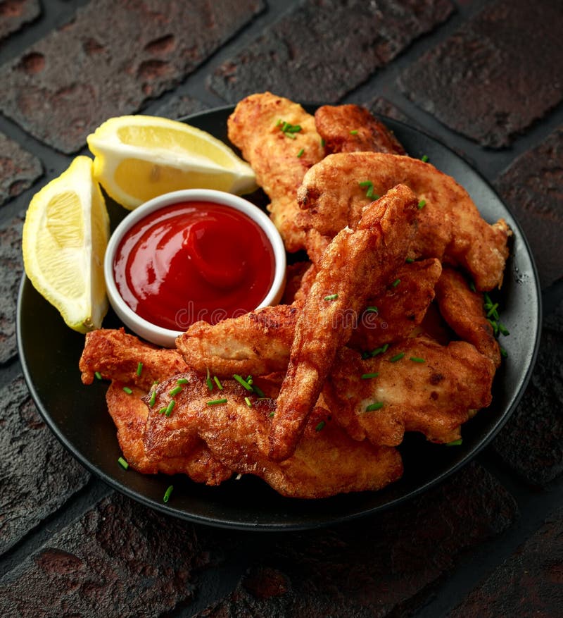 Fried Battered Chicken Breast Fillets Served with Lemon Wedges Stock ...