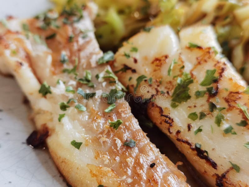 Fried cabbage with fish stock image. Image of produce - 224478457