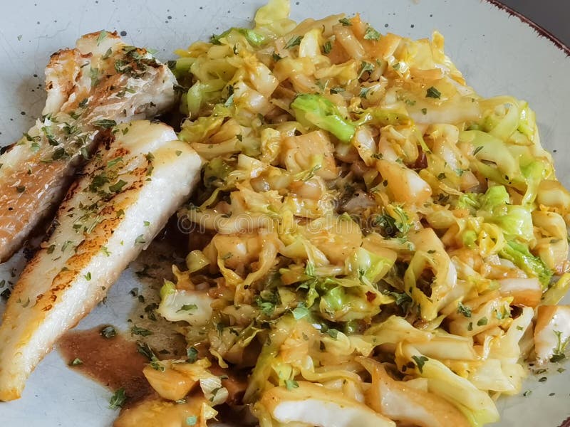 Fried cabbage with fish stock image. Image of food, fish - 224381061