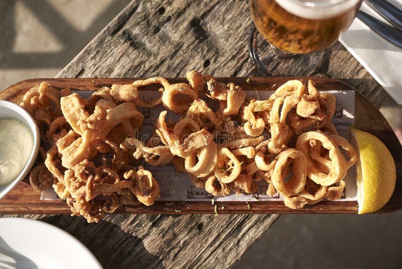 Fried calamari and a beer stock image. Image of lemon - 158269605