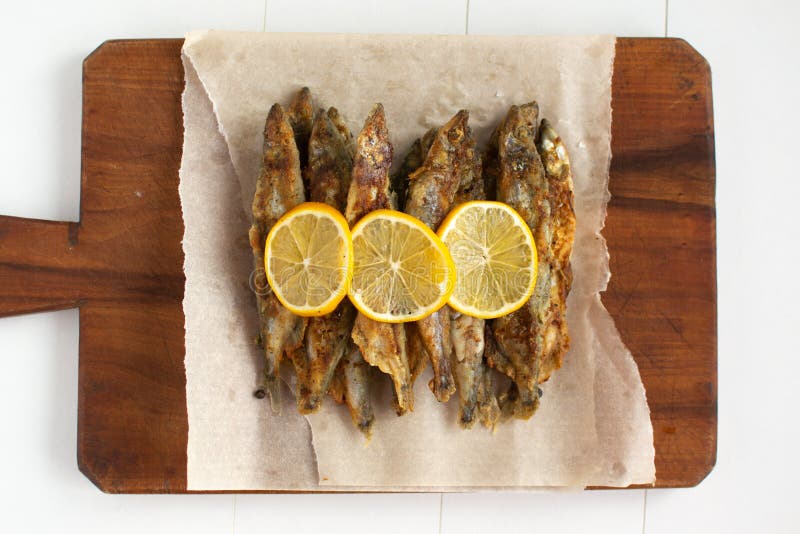 Fried Capelin with Lemon on Baking Paper on a White Backgroun Stock ...