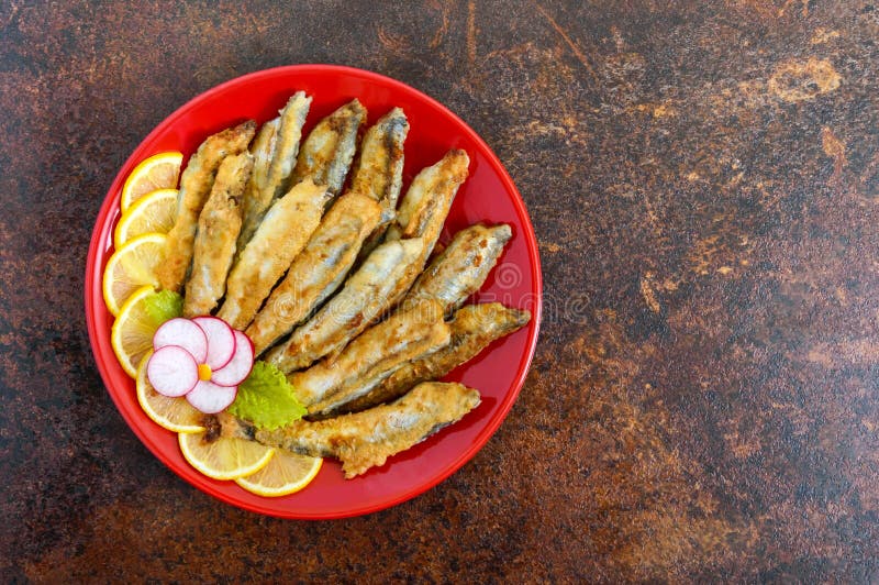 Fried Capelin with Lemon on a Red Plate. a Dish of Small Sea Fish. Top ...