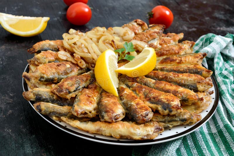 Fried Capelin, Sprats. Small Fried Fish on a Plate on a Black ...