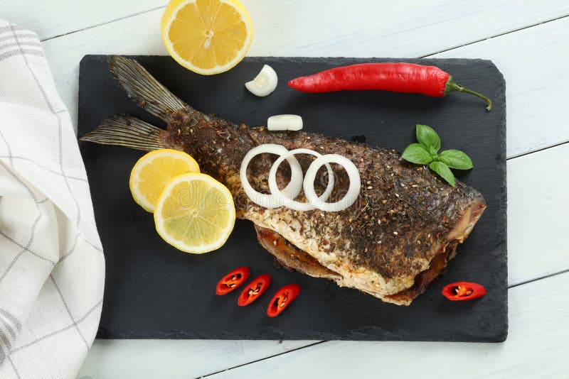 Fried Carp Fish with Vegetables, Tomatoes and Lemon. Grilled Fish Carp ...