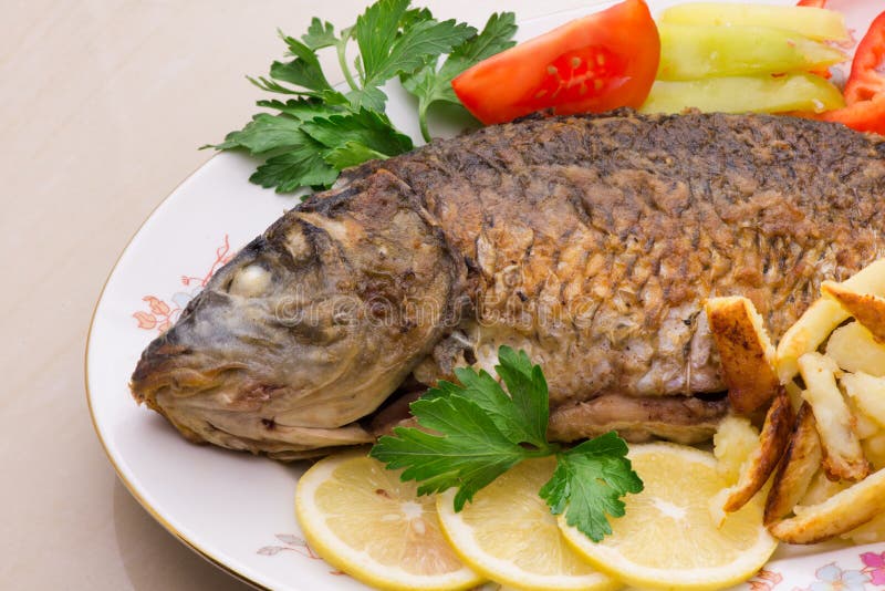 Fried Carp with Potato and Vegetables Stock Photo - Image of tomato ...