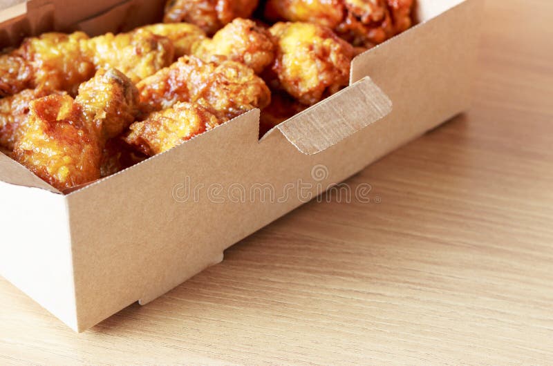 Fried Chicken in a Cardboard Box Stands on Table, Copy Space. Stock ...