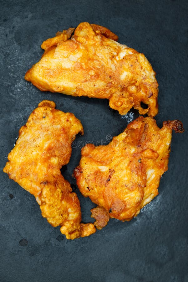 Fried Chicken Nuggets on Black Cast Iron Frying Pan Stock Image - Image ...