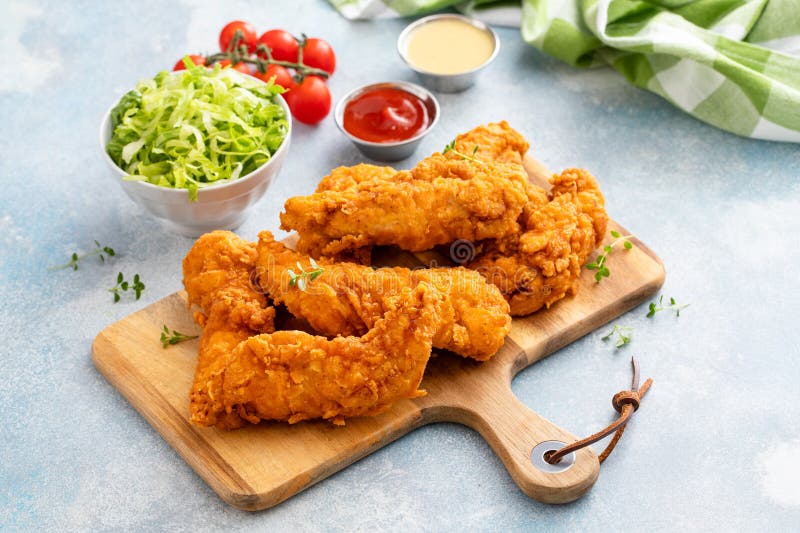 Fried Chicken Tenders on a Serving Board with Sauces and Salad Stock ...