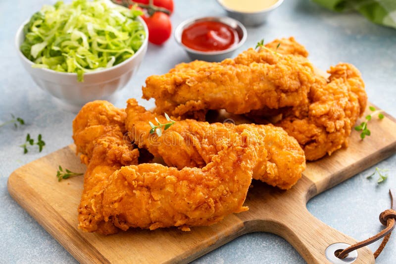 Fried Chicken Tenders on a Serving Board with Sauces and Salad Stock ...