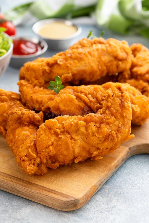 Fried Chicken Tenders on a Serving Board with Sauces and Salad Stock ...