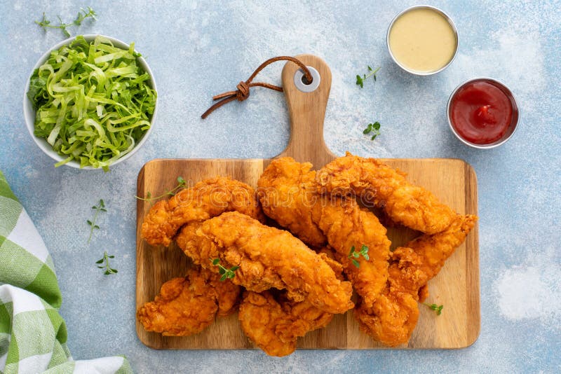 Fried Chicken Tenders on a Serving Board with Sauces and Salad Stock ...