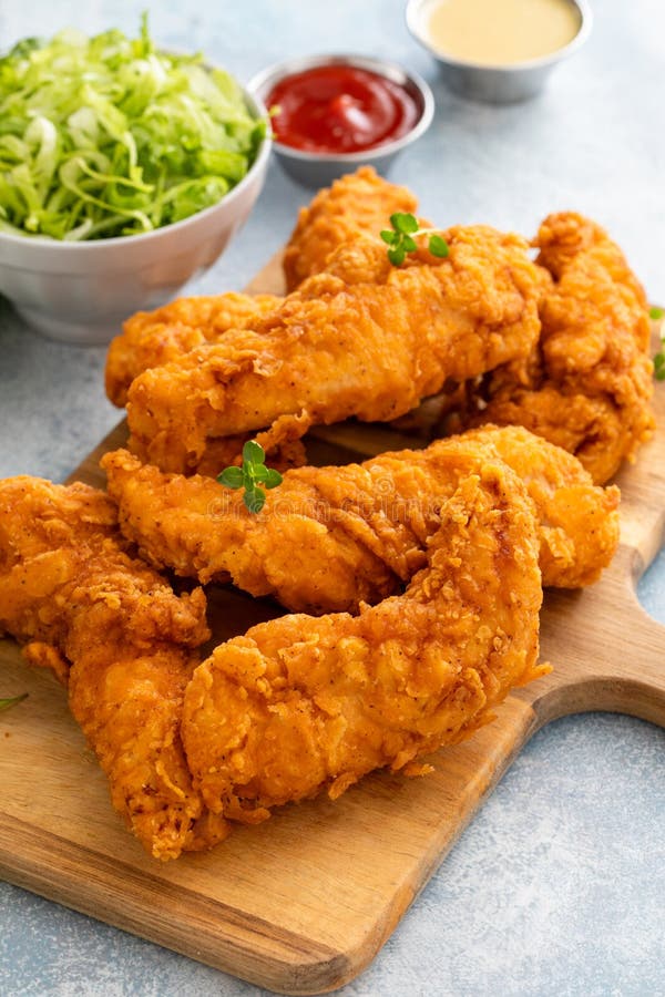 Fried Chicken Tenders on a Serving Board with Sauces and Salad Stock ...