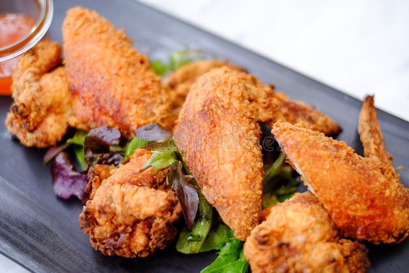 Fried Chicken Wings on Black Plate in Restaurant Stock Photo - Image of ...