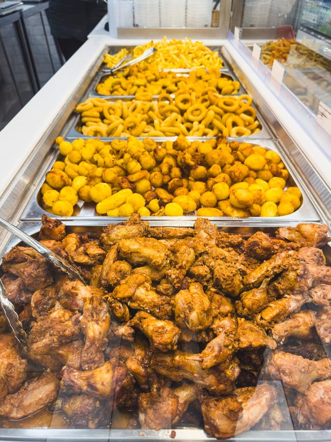 Fried Chicken Wings and Potatoes on a Counter in a Market Stock Photo ...
