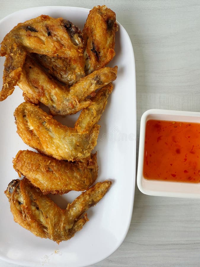 Fried Chicken Wings with Sticky Rice on a White Plate in a Restaurant ...