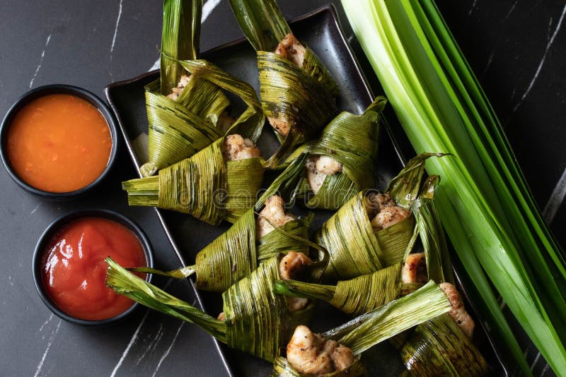 Fried Chicken Wrapped in Pandan Leaves in a Black Plate Stock Image ...