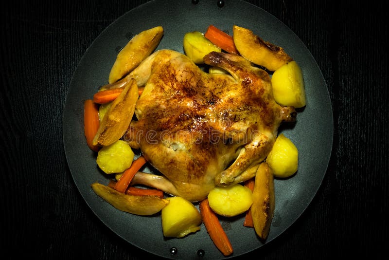 Fried Chiken with Vegetables on a Pan on a Black Wooden Table. T Stock ...