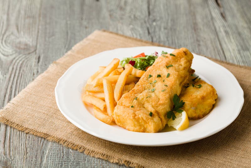 Fried Cod with Chips. Cod Fried in Breadcrumbs with Fries and Salad ...