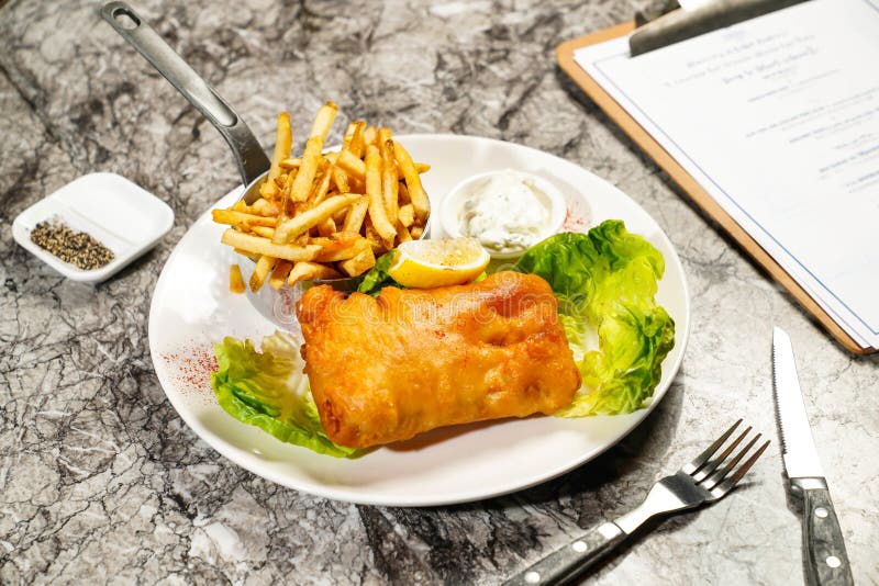 Fried Cod Fish and Chips with Tartar Sauce with Lemon, Fork and Knife ...