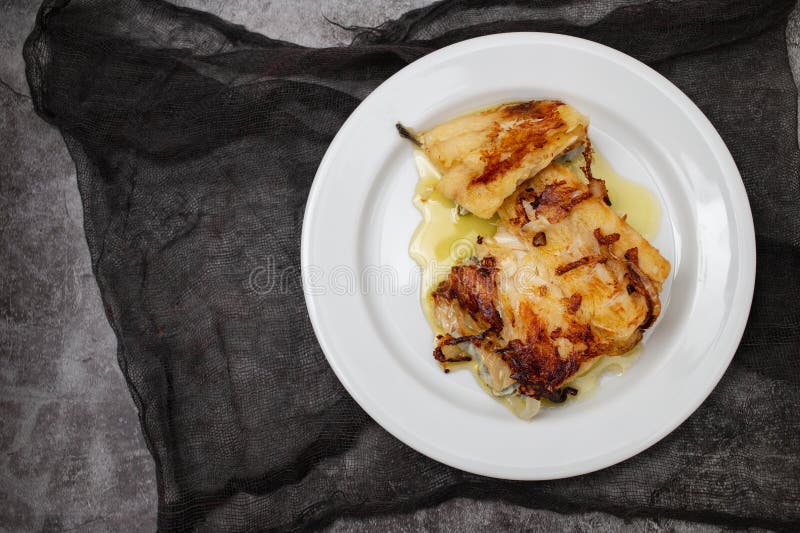 Fried Cod Fish with Olive Oil on White Dish Stock Photo - Image of ...