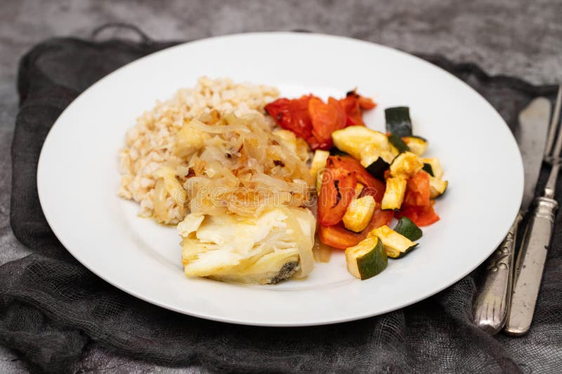 Fried Cod Fish with Onion, Vegetables, Rice and Olive Oil on Plate ...