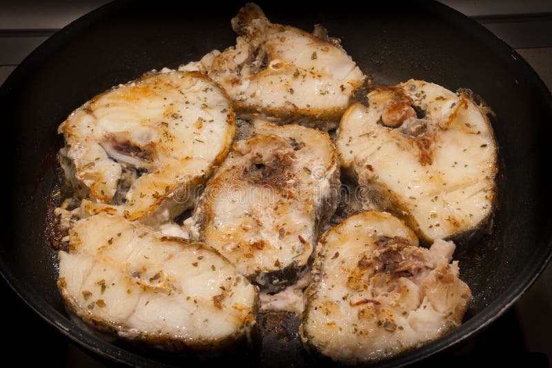 Fried Cod Fish in a Pan with Condiment and Herbs Stock Image - Image of ...