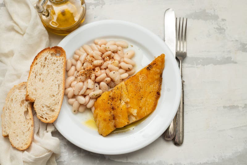 Fried Cod Fish with White Beans on the Plate. Stock Image - Image of ...