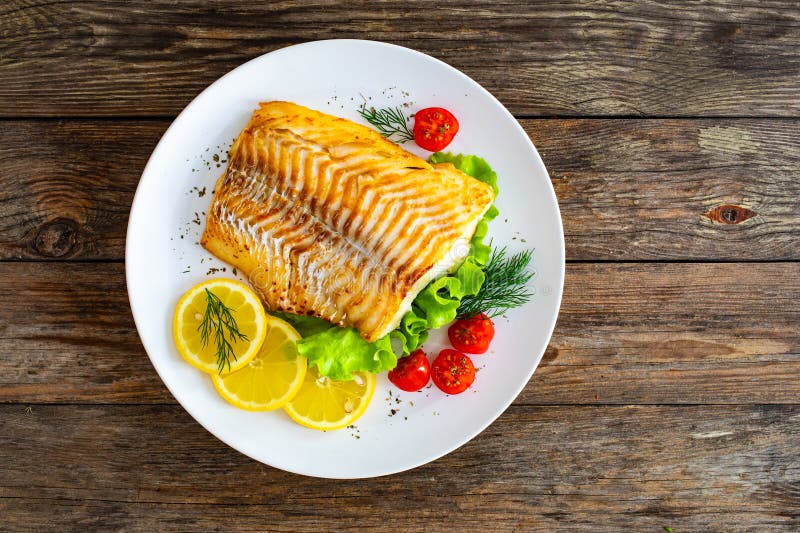 Fried Cod Loin and Fresh Vegetables on Wooden Table Stock Image - Image ...