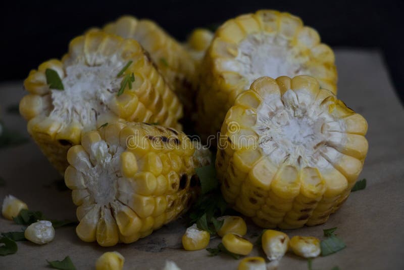 Fried Corn on Parchment Paper with Fine Herbs and Butter. Black ...