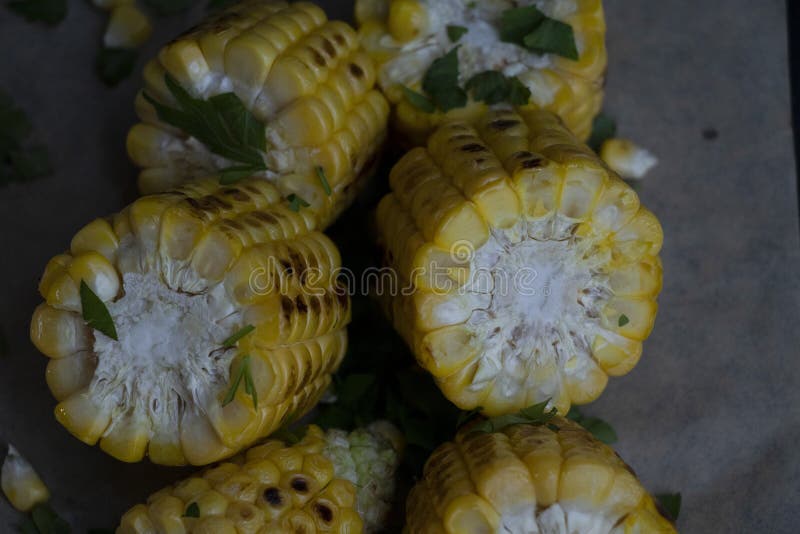 Fried Corn on Parchment Paper with Fine Herbs and Butter. Black ...