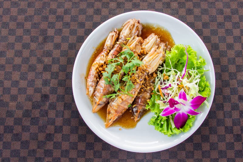 Fried Crayfish with Garlic Decorated with Purple Orchid on a White ...