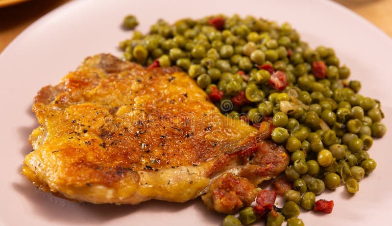 Delicious Crispy Chicken with Peas As a Side Dish on a Plate Stock ...