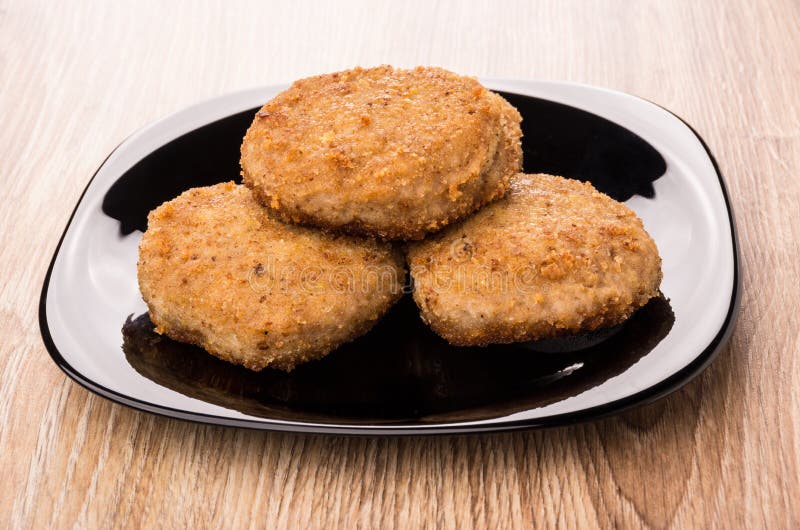 Fried Cutlets in Black Plate on Table Stock Image - Image of wooden ...
