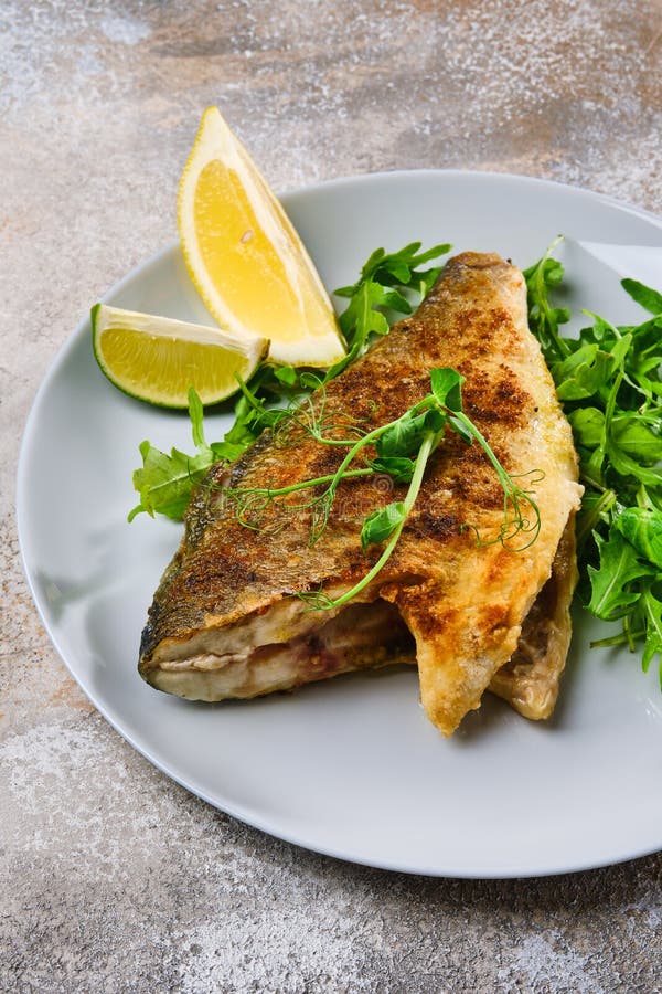 Fried Dorada Fish with Fresh Arugula Stock Image - Image of dinner ...