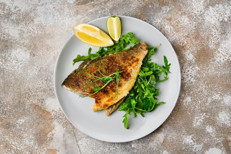 Fried Dorada Fish with Fresh Arugula Stock Image - Image of fried ...