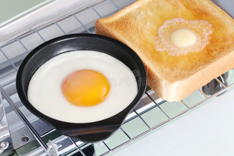Fried Egg and Baked Golden Toast in Toaster Oven Stock Photo - Image of ...