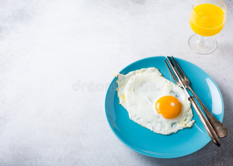 Fried egg and orange juice stock image. Image of view - 92537909