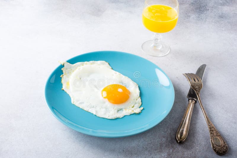 Fried egg and orange juice stock image. Image of view - 92537909