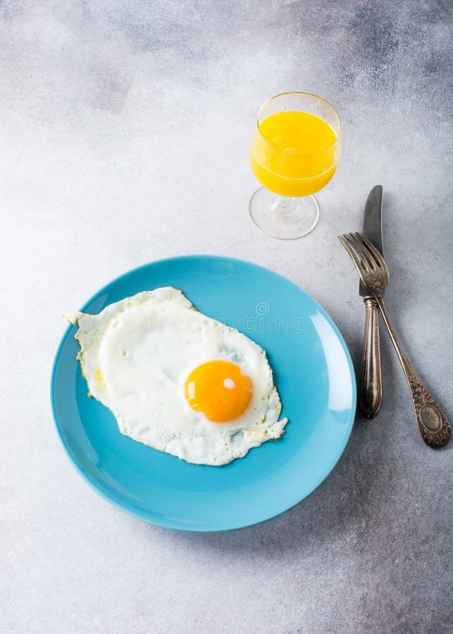 Fried egg and orange juice stock image. Image of view - 92537909