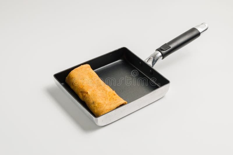 Fried egg in square pan stock image. Image of roll, flatware - 71785319