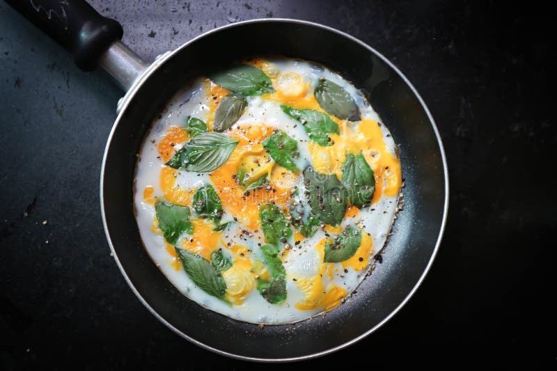 Fried Egg with Sweet Basil and Holy Basil in the Pan Stock Photo ...