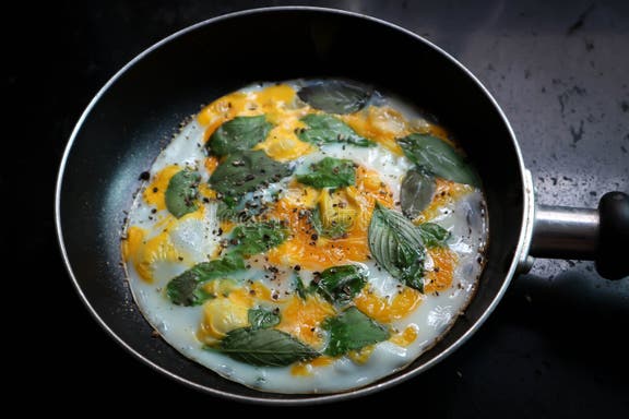 Fried Egg with Sweet Basil and Holy Basil in the Pan Stock Image ...