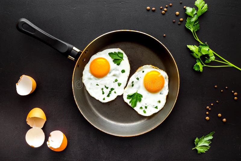 Fried Eggs on Frying Pan on Black Desk Top-down Stock Photo - Image of ...