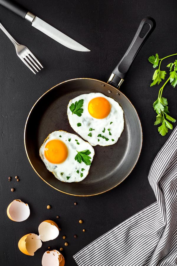 Fried Eggs on Frying Pan on Black Desk Top-down Stock Photo - Image of ...