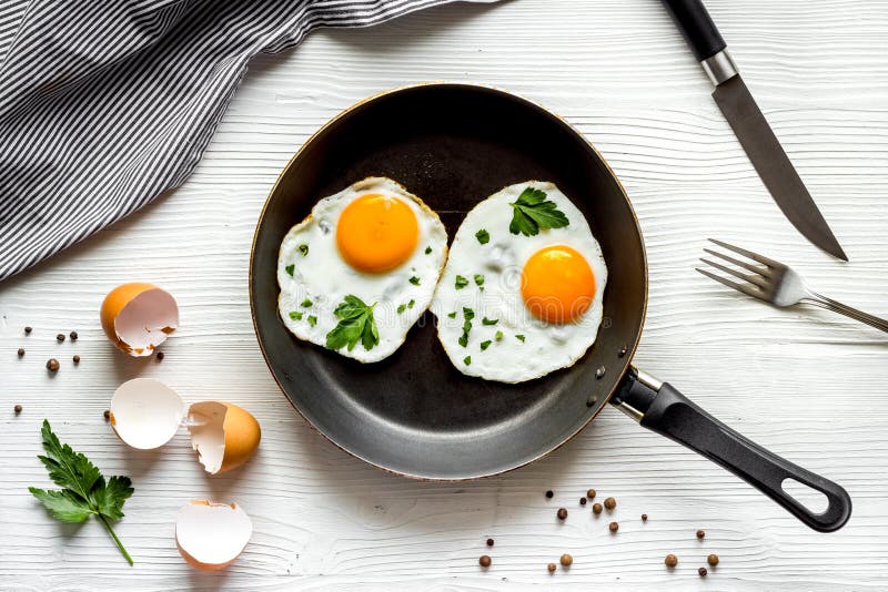 Fried Eggs on Frying Pan on White Table Top-down Stock Image - Image of ...