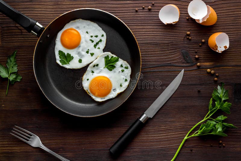 Fried Eggs on Frying Pan on Wooden Table Top-down Stock Image - Image ...