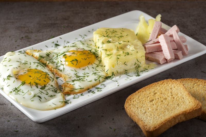 Fried Eggs with Melted Romanian Cheese Called Cas and Some Parizer ...