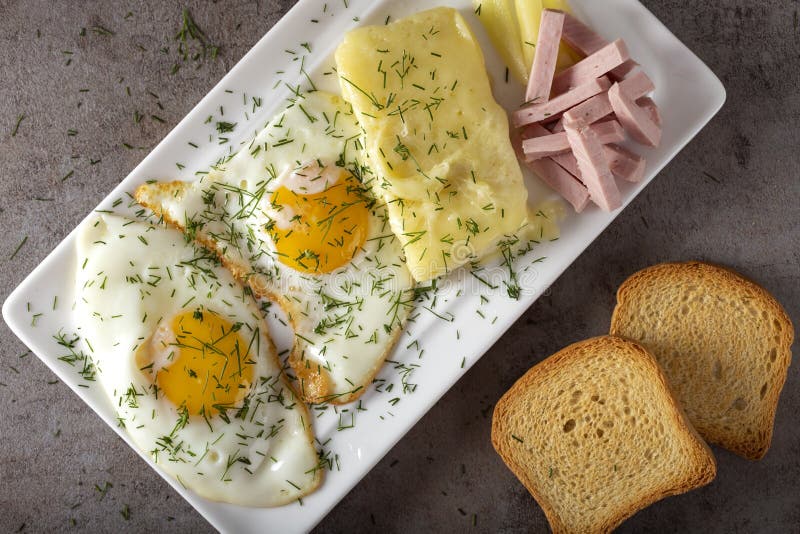 Fried Eggs with Melted Romanian Cheese Called Cas and Some Parizer ...